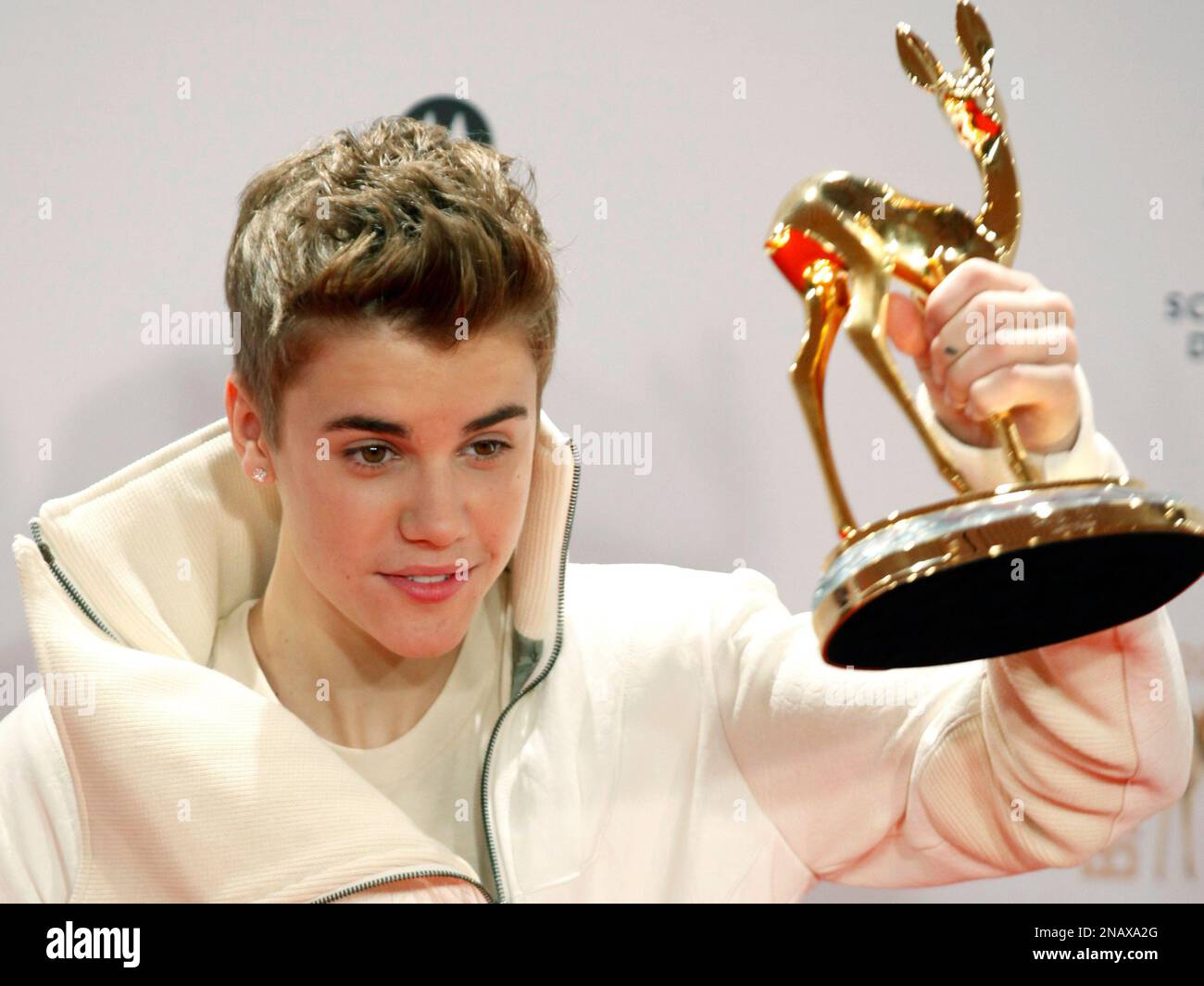 Canadian singer Justin Bieber presents the trophy for best ...
