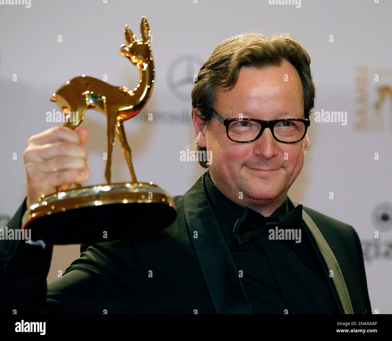 German actor Matthias Brandt poses with the trophy after receiving the ...