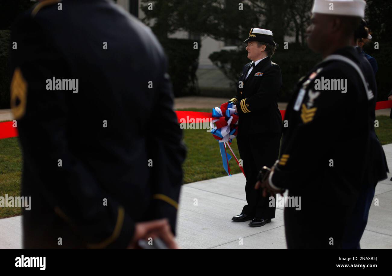Commander Moira McGuire holds part of the ceremonial ribbon that Sec ...