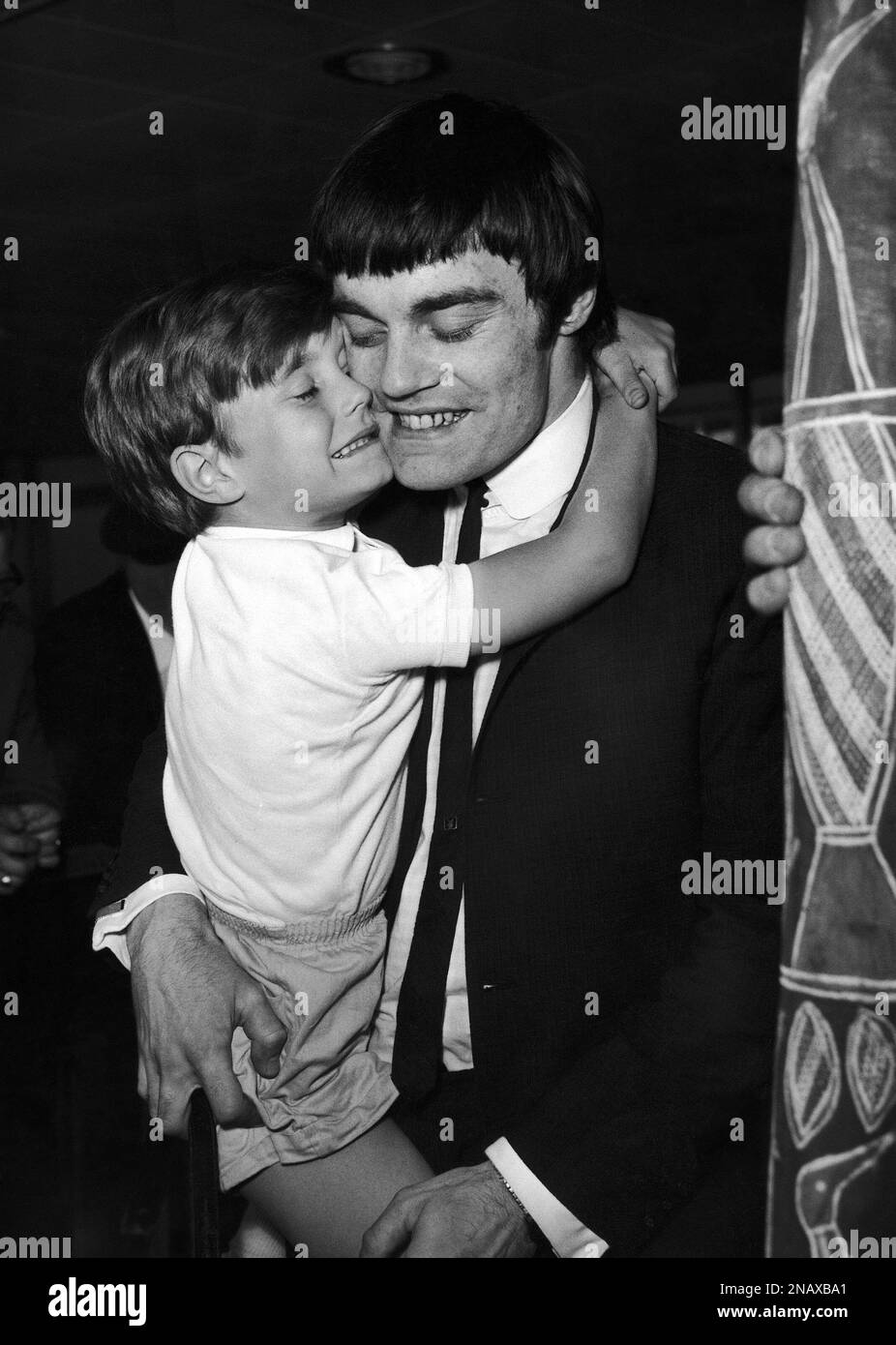Drummer Jimmy Nicol, 24, is greeted by his four-year-old son, Howard ...