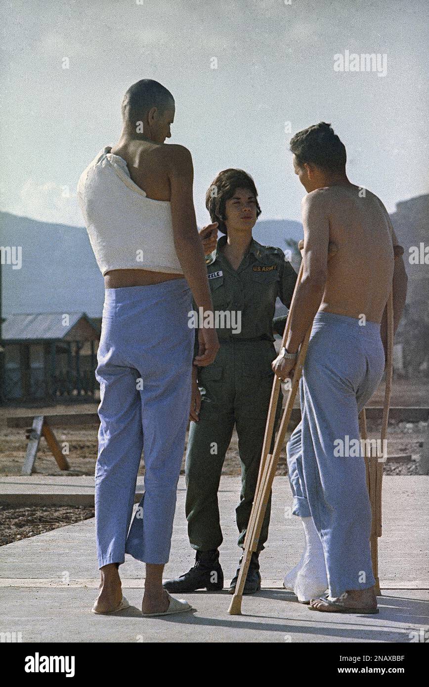 Army nurse 2nd Lt. Roberta Steele, walks with patients Sgt. William F ...