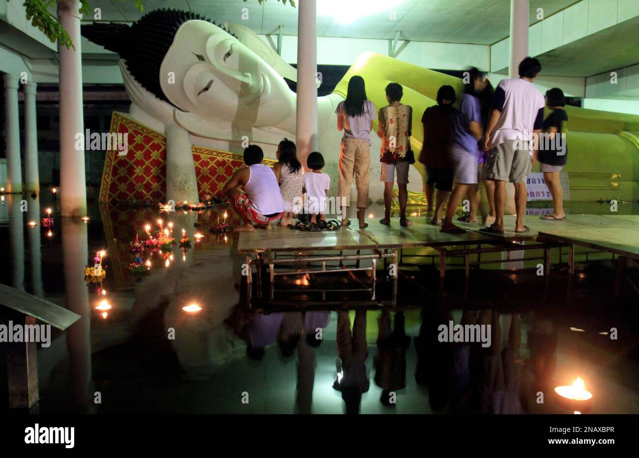 Buddhist Thais float their Krathongs, small lanterns made of banana ...