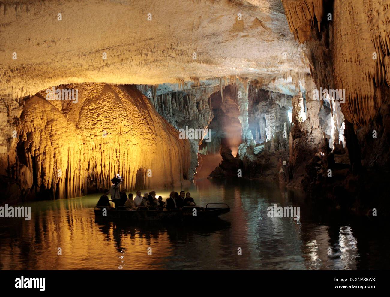 Arabs tourist take a boat tour in the lower cave of the Jeita Grotto ...