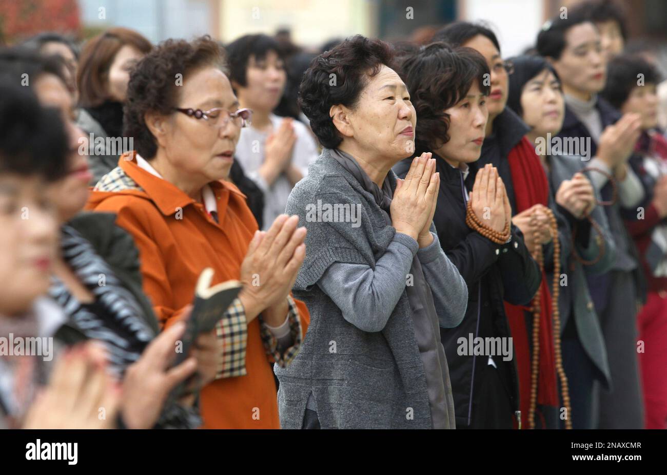 South Korean parents pray during a special service to wish for their ...