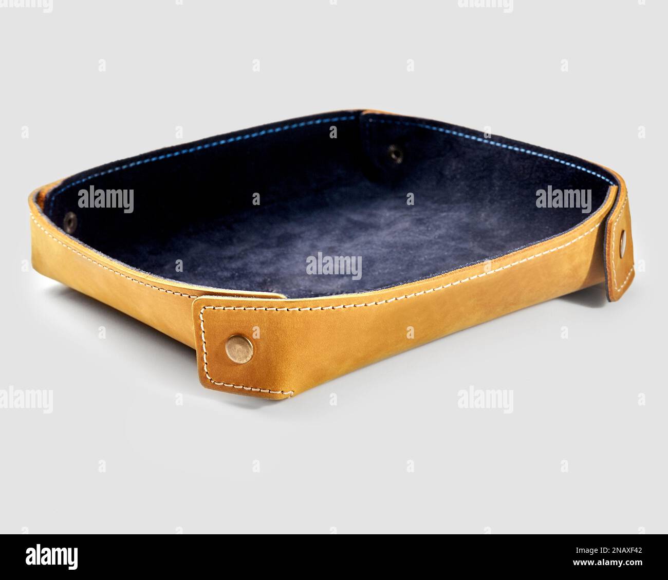 Handmade sand colored leather tray for keeping keys Stock Photo - Alamy