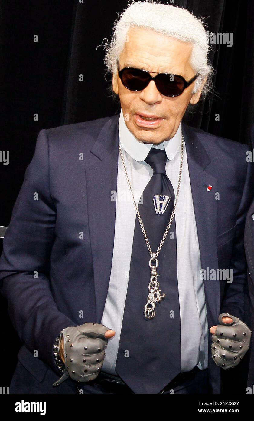 Fashion designer Karl Lagerfeld poses front of a Parisian department ...