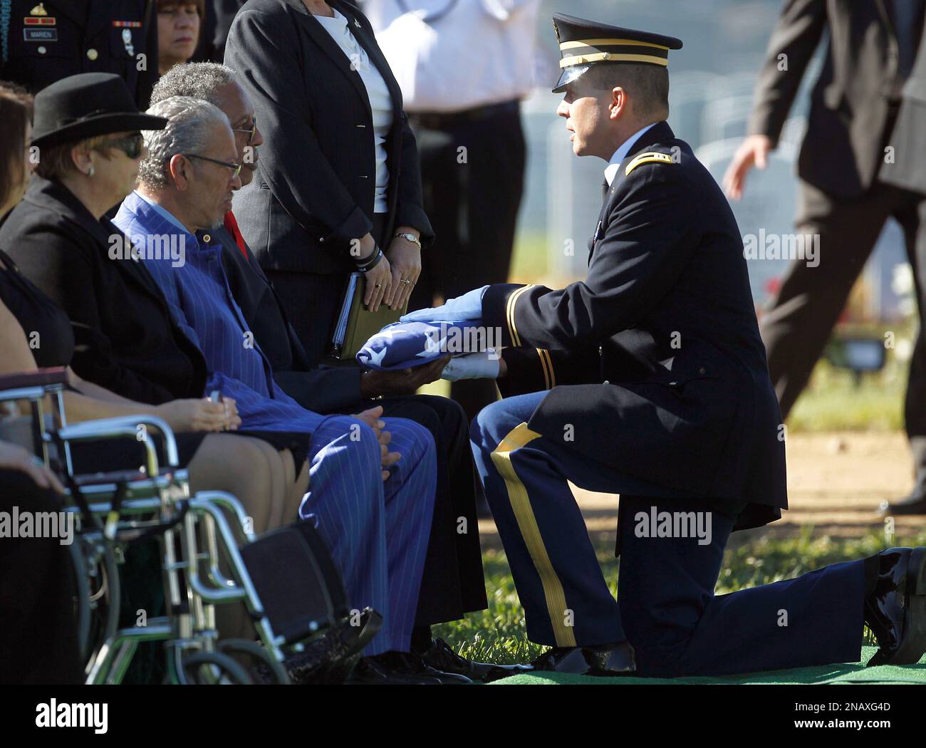 Chaplain Capt. Scott Kennaugh, right, presents the US flag to Homer ...