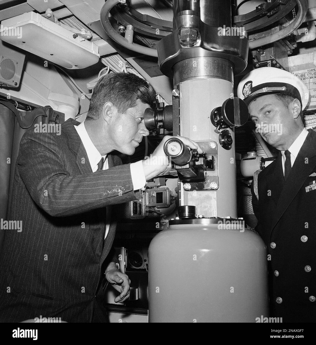 President John. F. Kennedy looks through the periscope of the nuclear ...