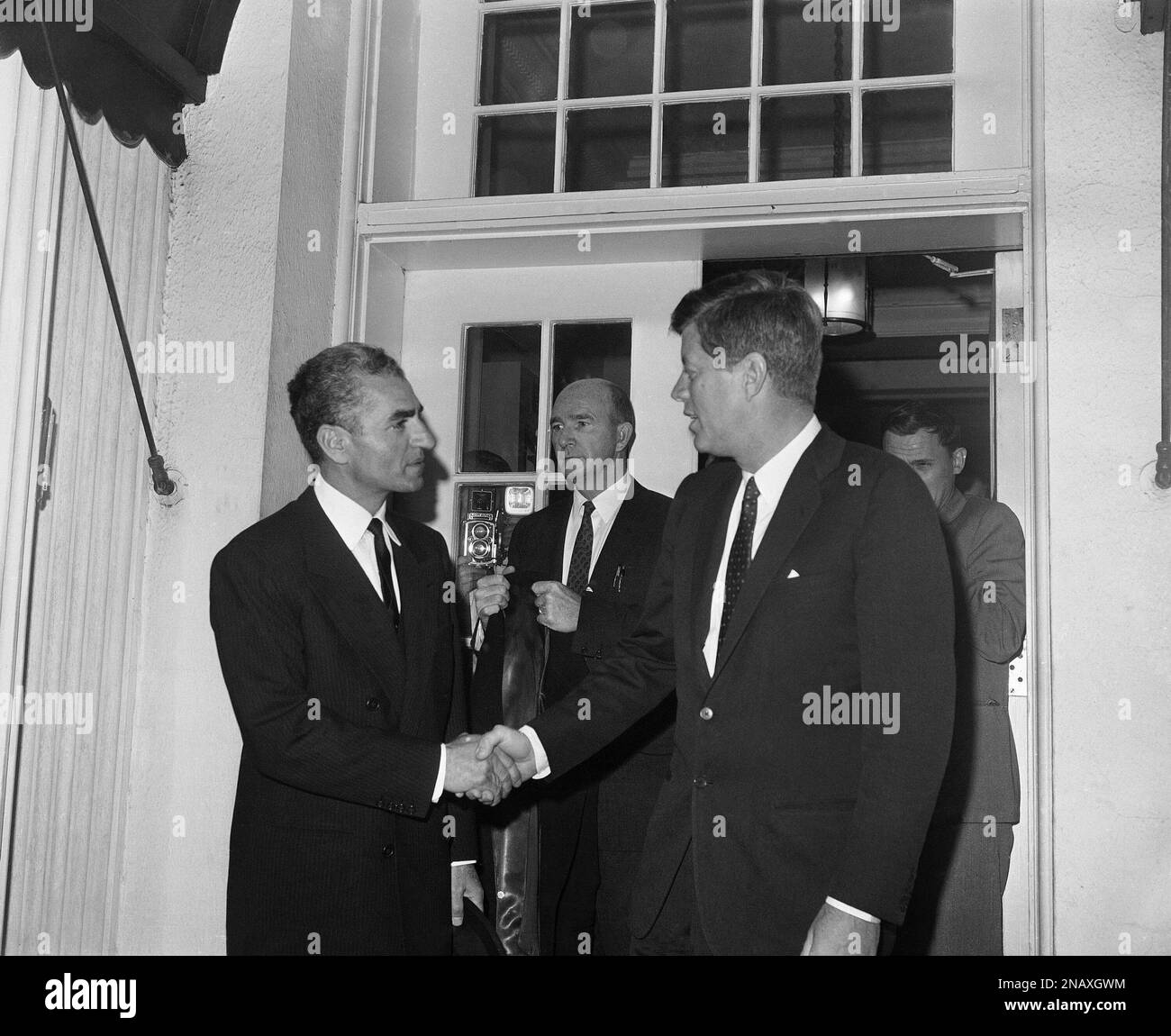 The Shah of Iran and President John F. Kennedy shake hands outside the ...
