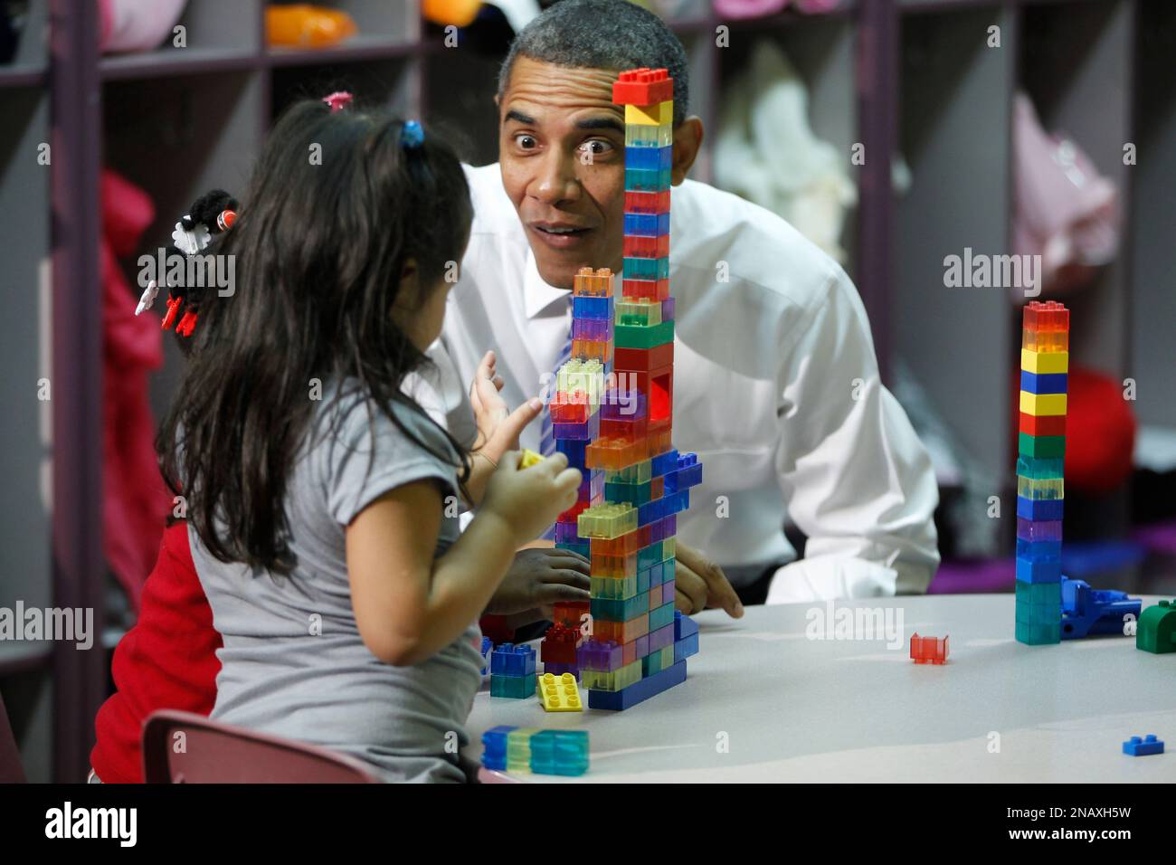 President Barack Obama reacts as a child plays with Lego style building ...