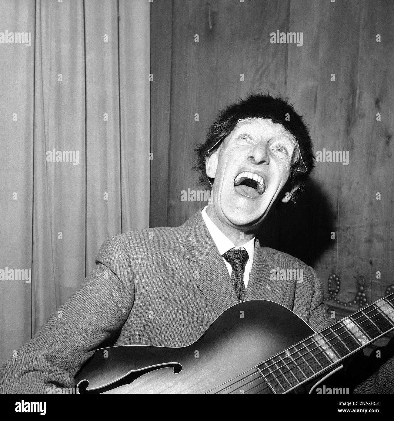 British actor Wilfred Brambell, in a Beatle wig at a press reception ...