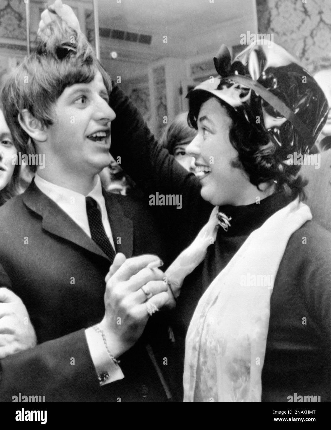 Beatle drummer Ringo Starr registers surprise, or maybe pain as Joan ...