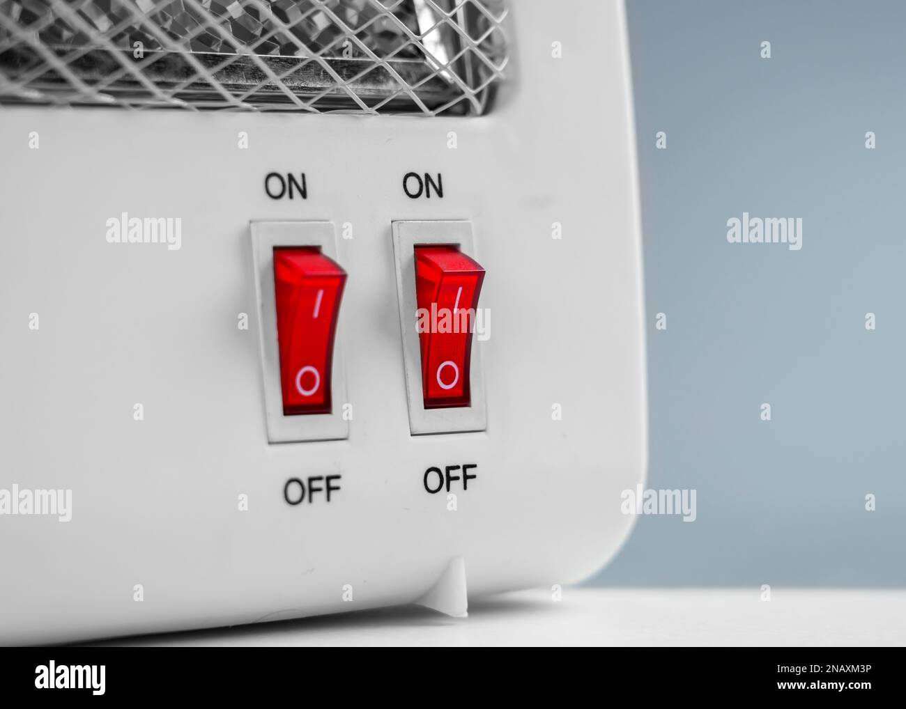 Turned off electrical appliance heater with reflector and red switches ...