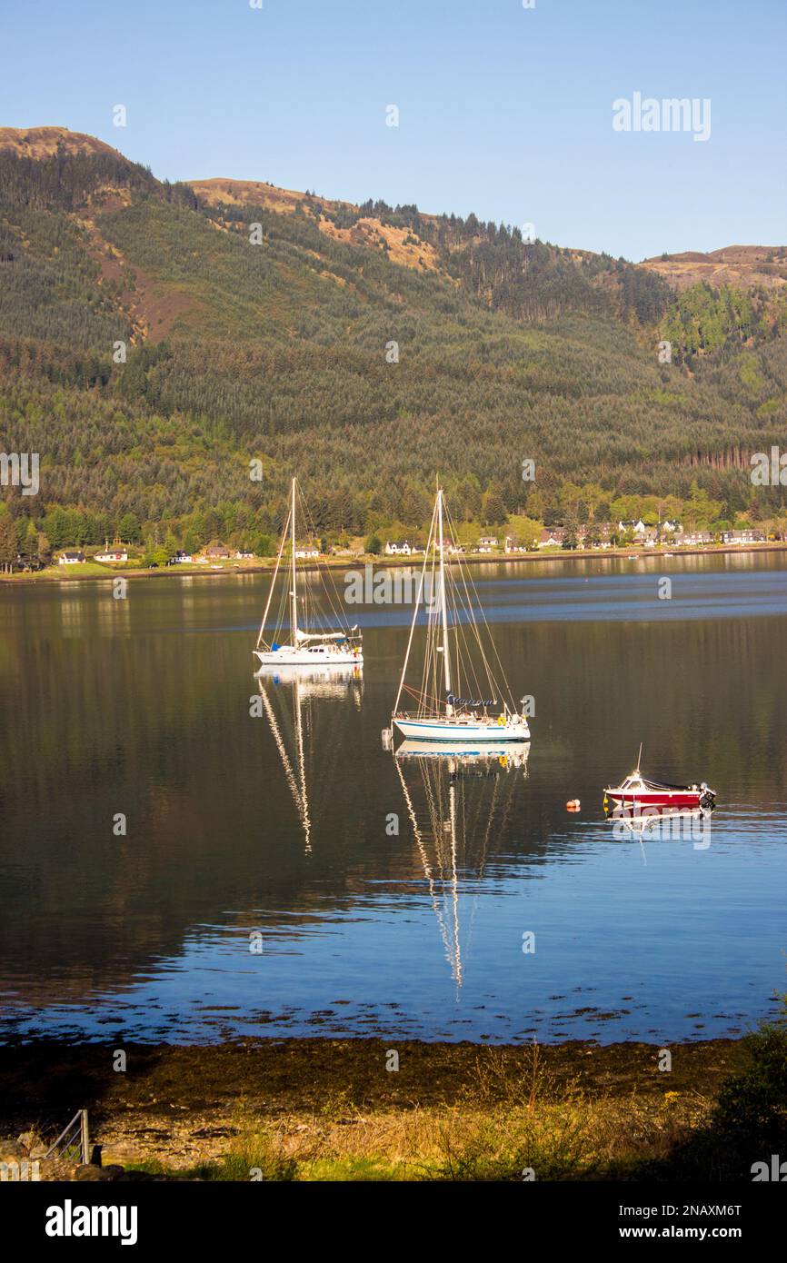 Two Sailboats on the calm waters of loch Duich, on a clear sunny day in ...