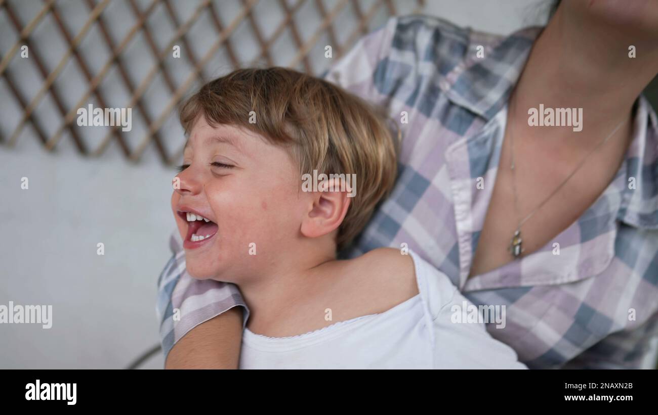 Happy Child and mother laughing and smiling together. Parenting ...
