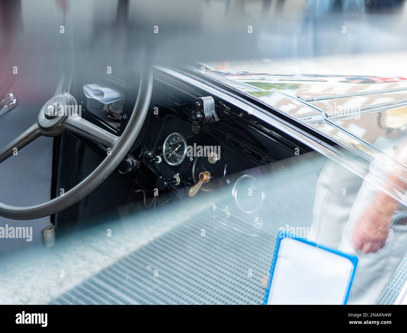 A detail of the interior of an old car as seen through a half open ...
