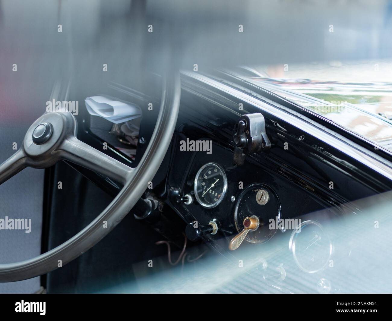A detail of the interior of an old car as seen through a half open ...