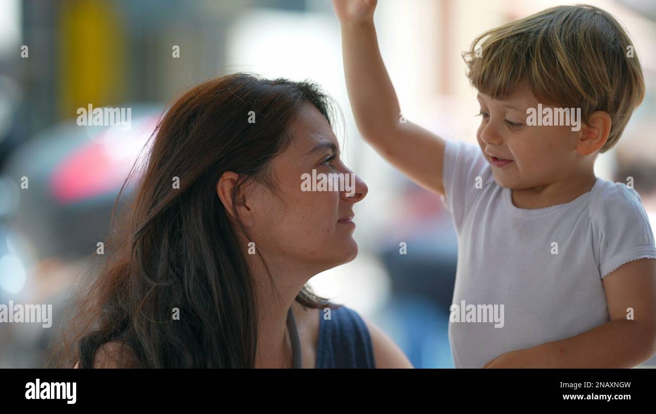 Child hitting mother head outside. Mom having patience. Parent ...