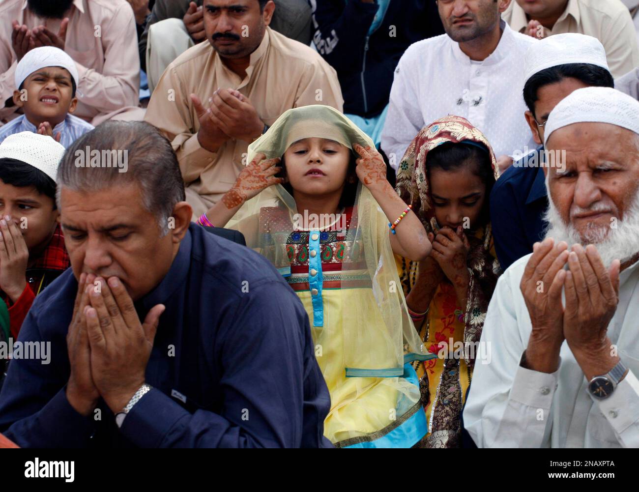 People offering the Eid-al-Adha prayers in Peshawar, Pakistan on Monday ...
