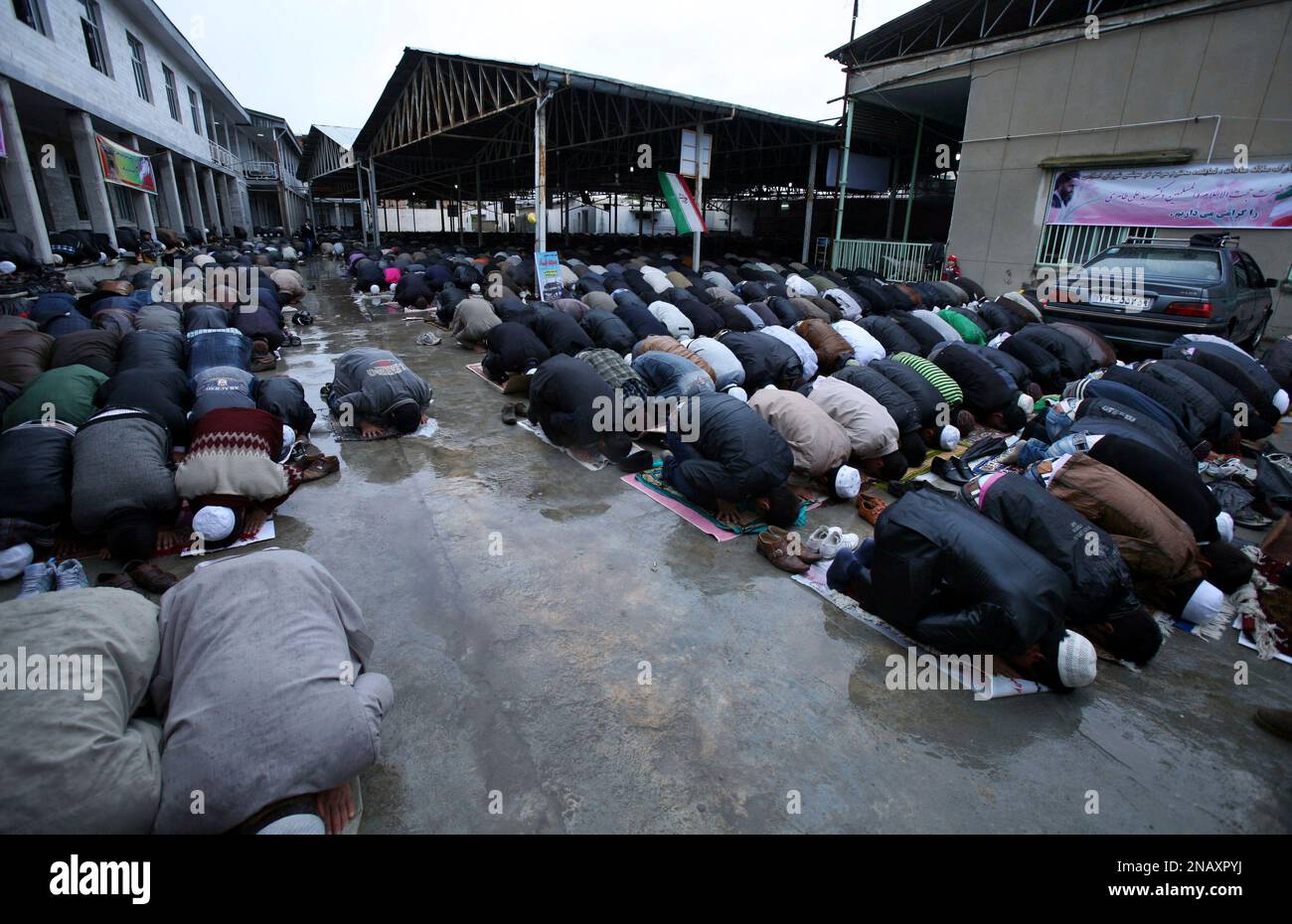In rainy weather, Iranian Sunni Muslims perform their Eid al-Adha ...