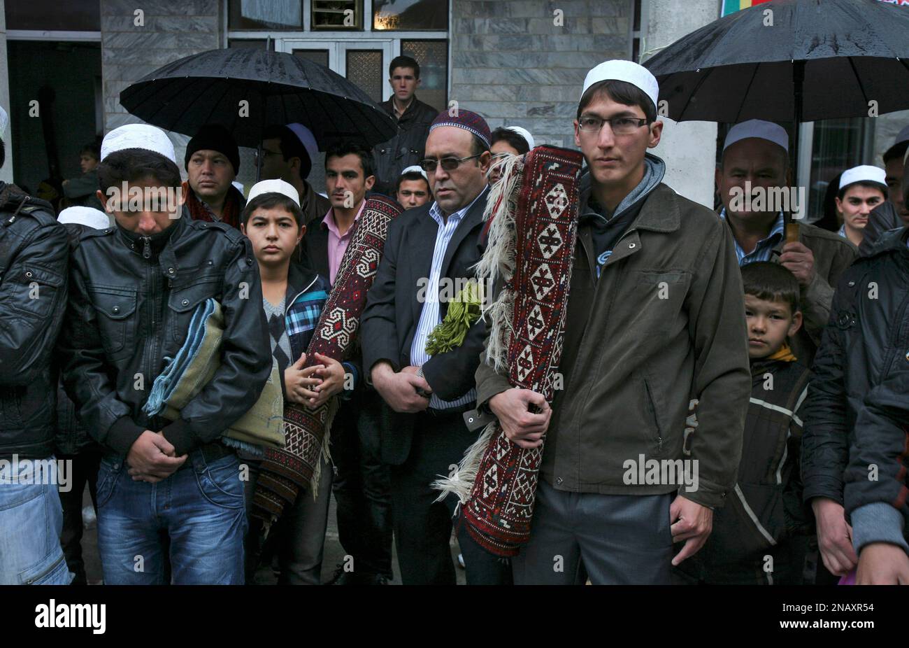 In rainy weather, Iranian Sunni Muslims, prepare to perform their Eid ...