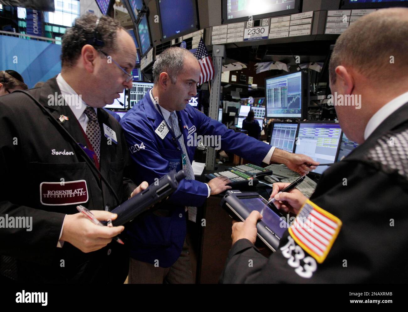 Specialist Michael Volpe, center, works on the floor of the New York ...
