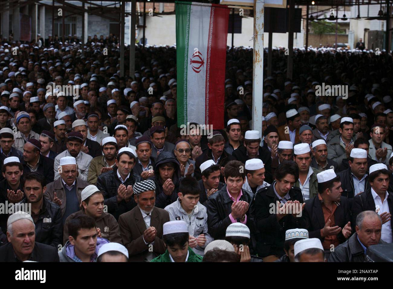 Under Iran's national flag, Iranian Sunni Muslims attend Eid al-Adha ...