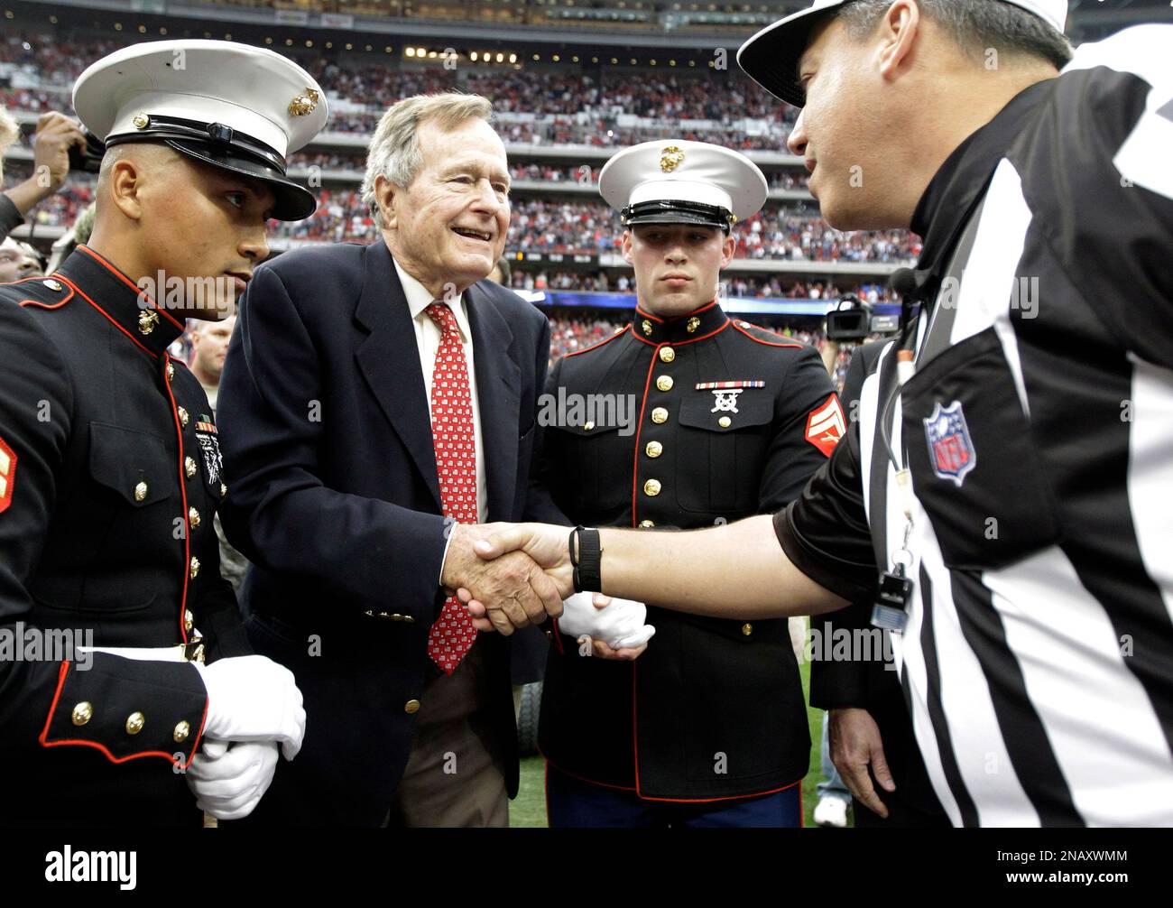 Former President George H.W. Bush, left, shakes hands with NFL referee ...