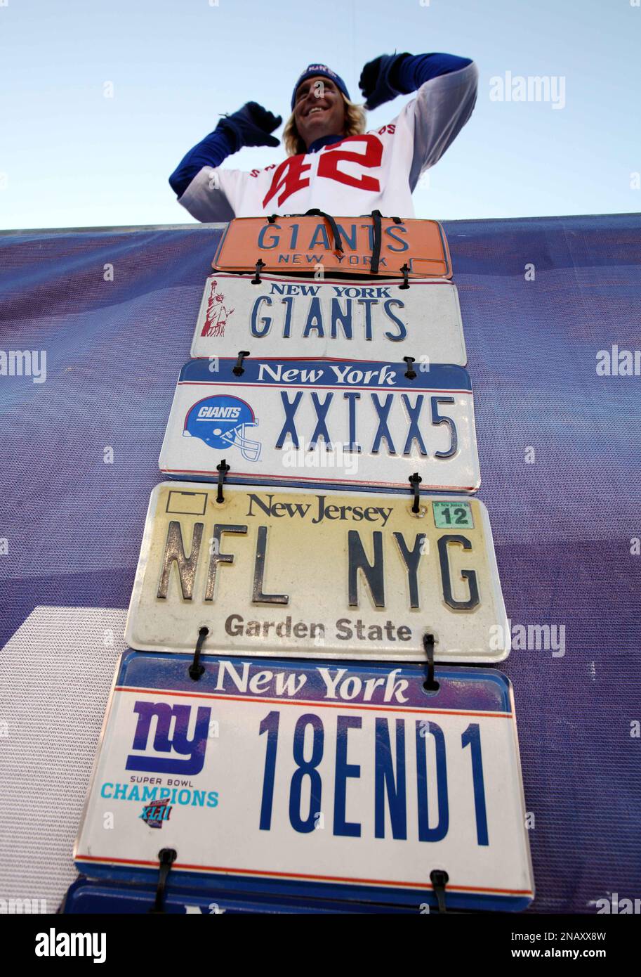 Joe Ruback, of New City, N.Y., watches warmups above his collection of ...