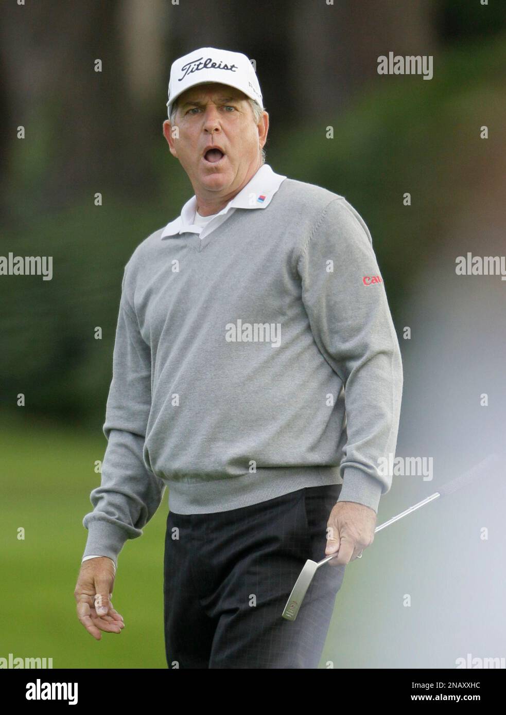Jay Haas reacts after a long putt close to the hole on the 17th green ...