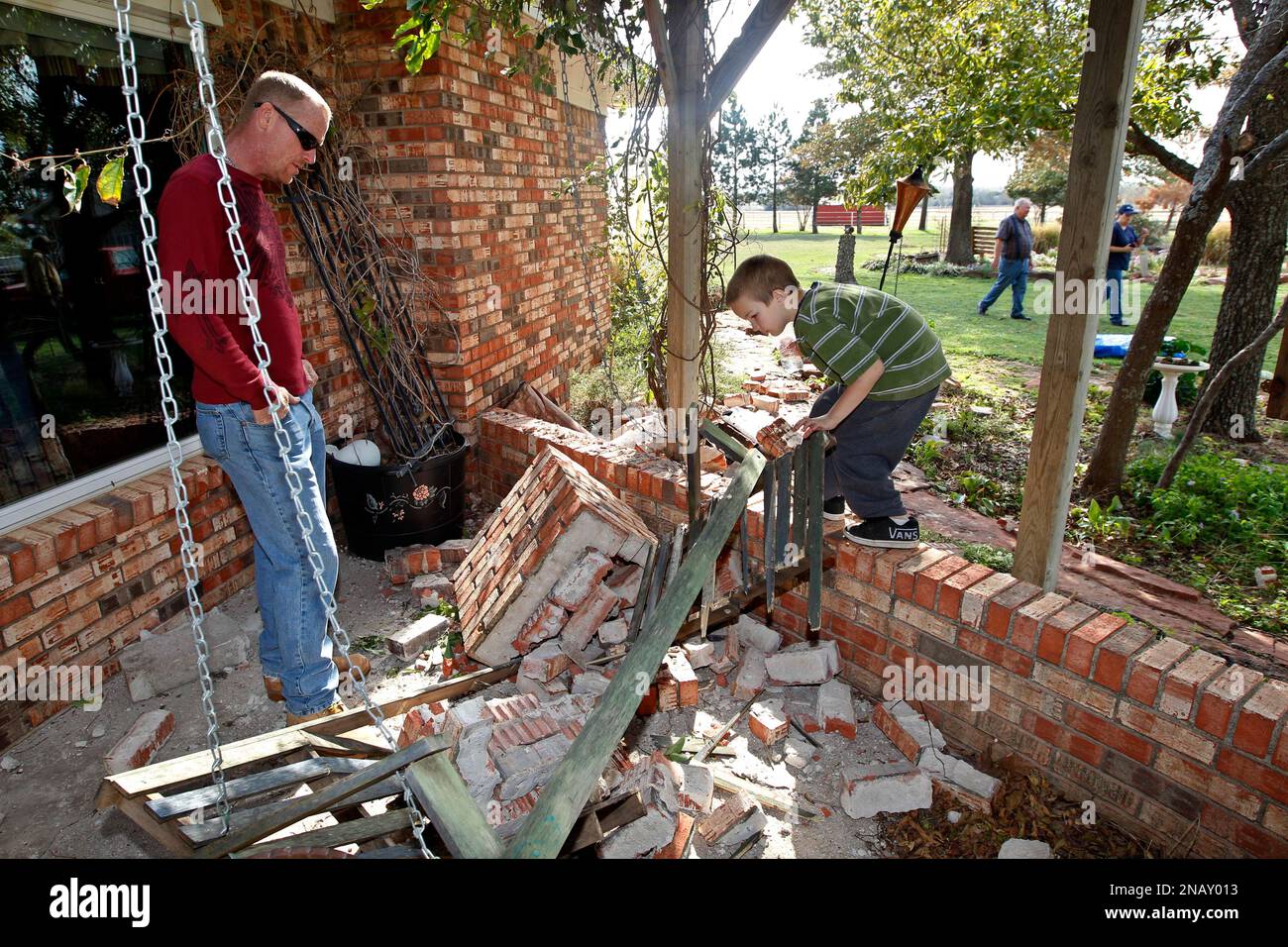 Jess Burrow, left, and James Patterson, look over the damage caused ...