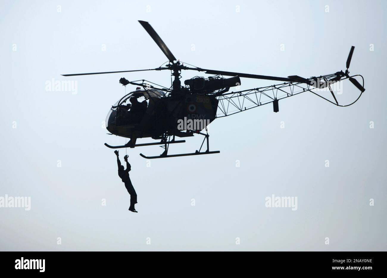 An Indian army helicopter lifts a soldier during a display held to ...