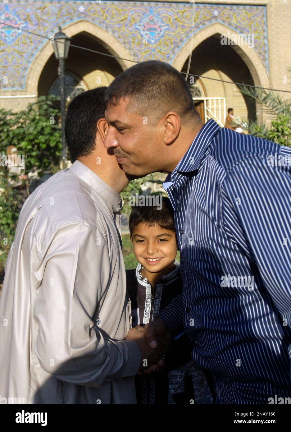Iraqi Muslims exchange greetings after Eid prayers outside the 14th ...