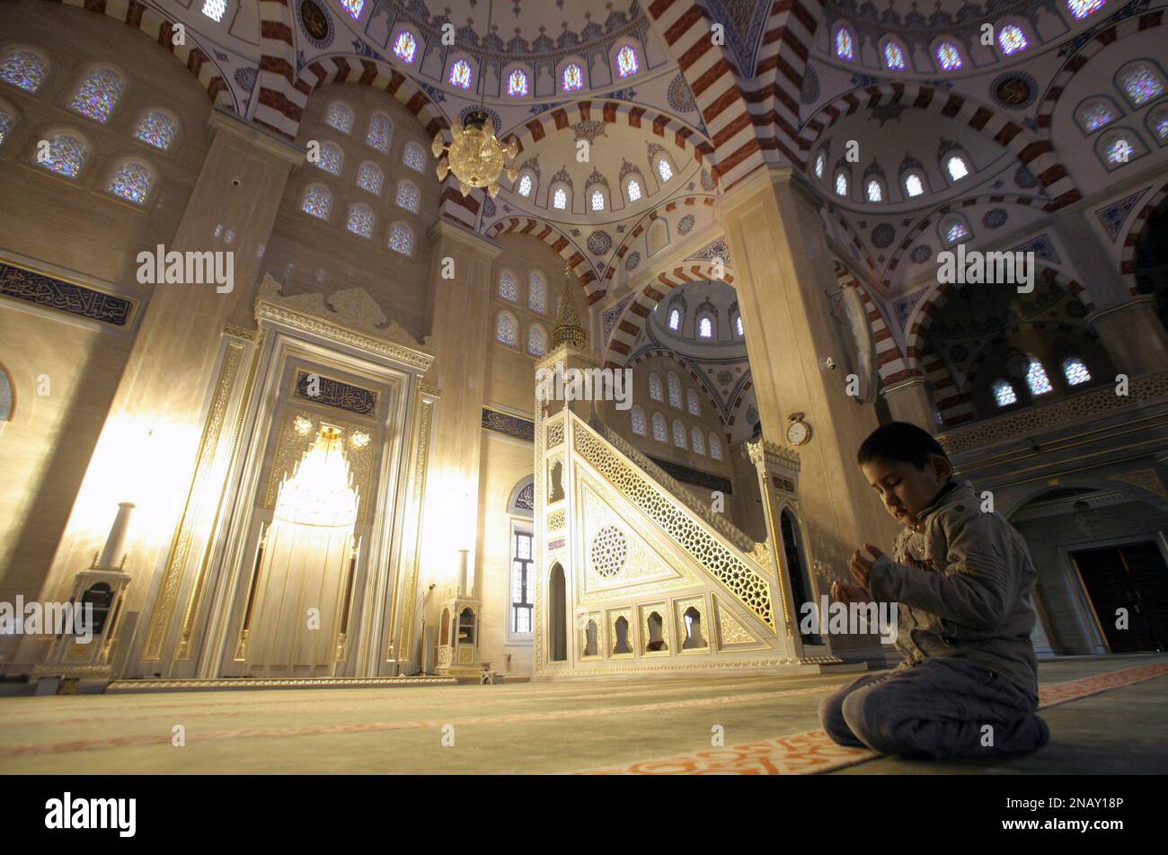 A Chechen boy prays in the main mosque in Grozny, Russia, during ...