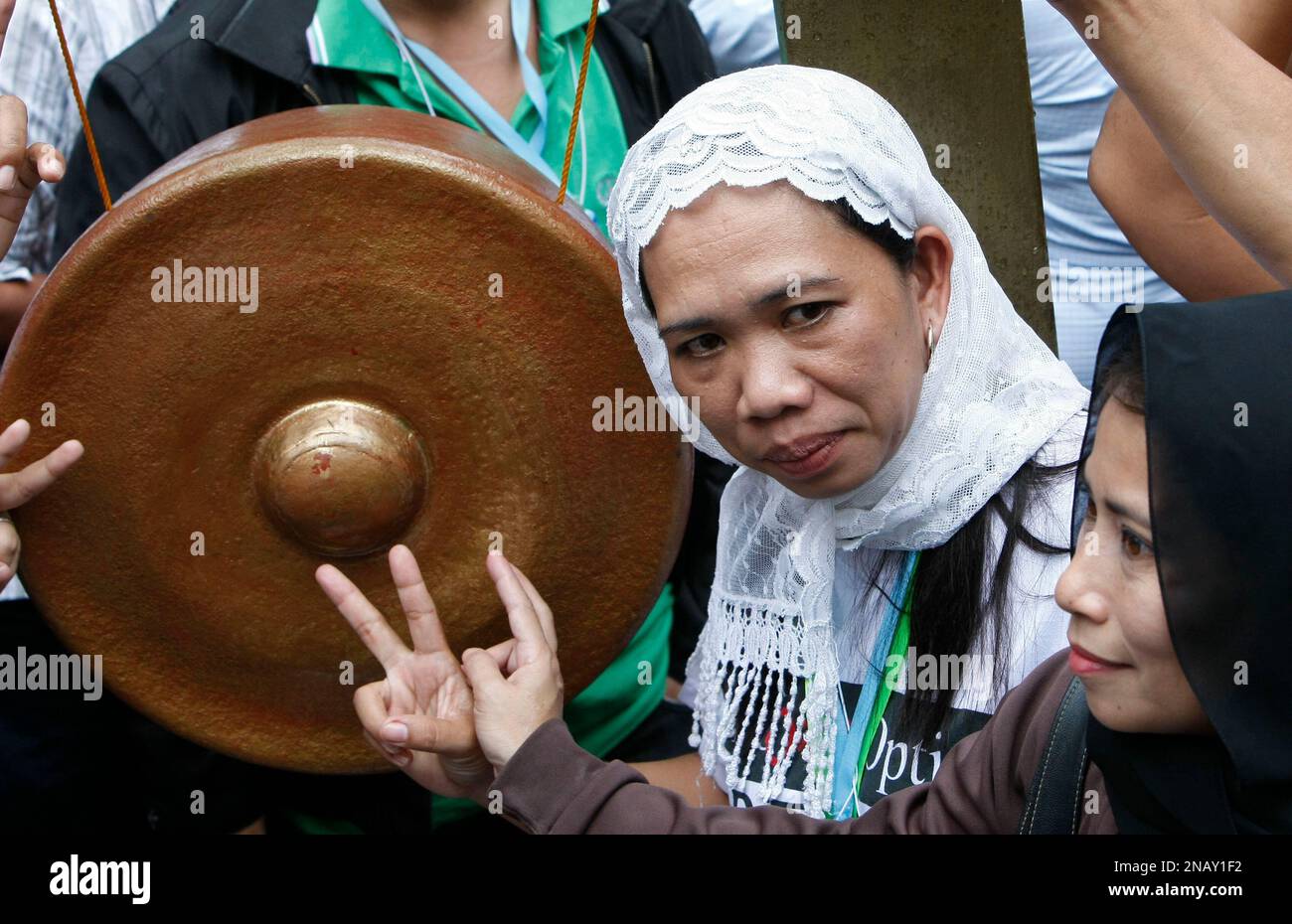 Filipino Muslims flash the peace sign during an unveiling ceremony of a ...