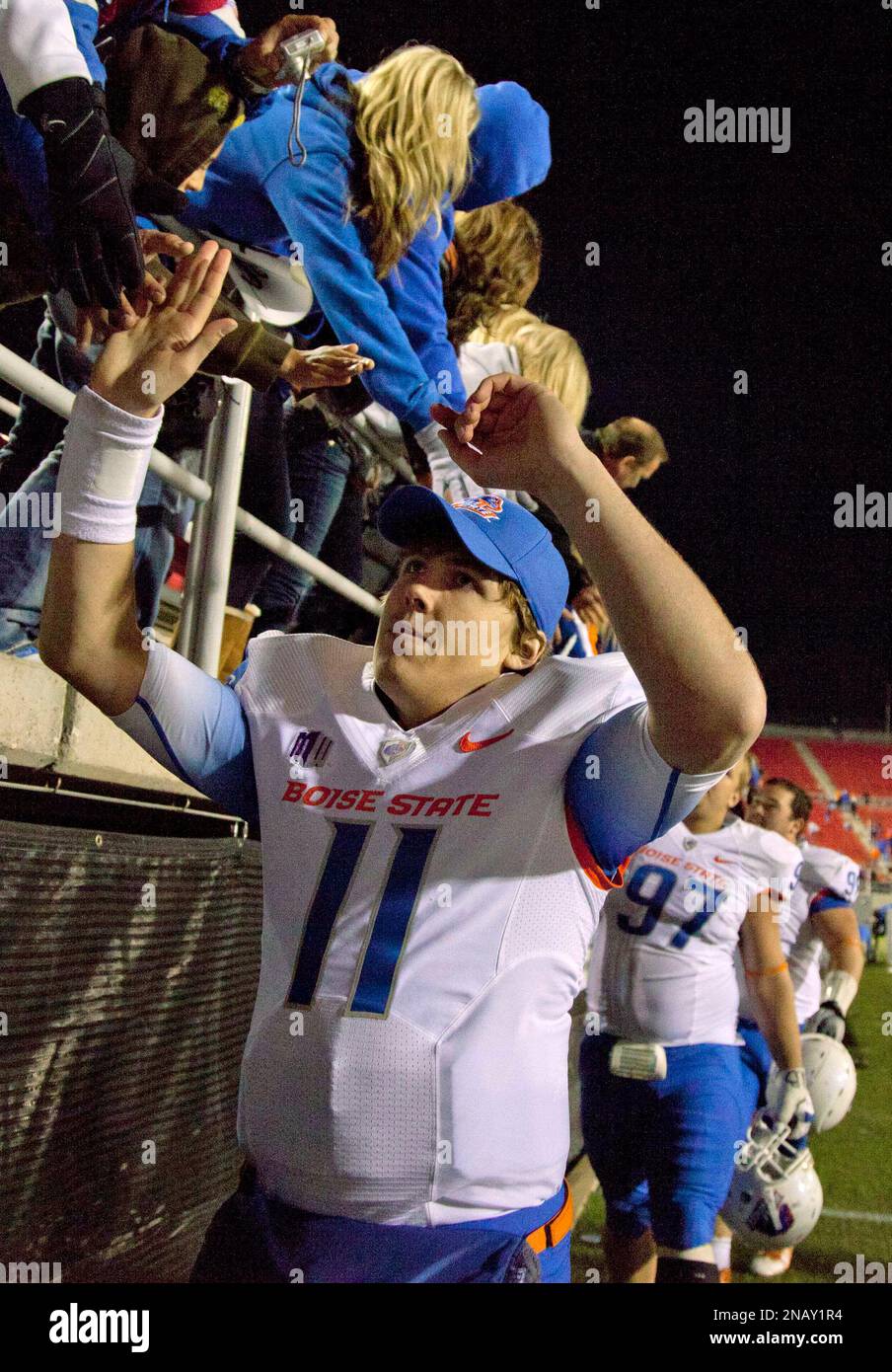 Boise State quarterback Kellen Moore (11) is congratulated by fans ...