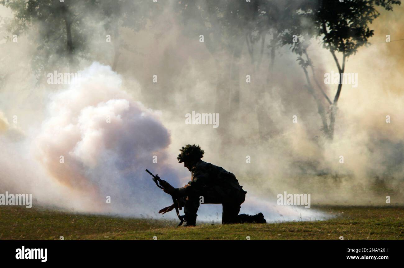 An Indian army soldier demonstrates a combat operation during a ...