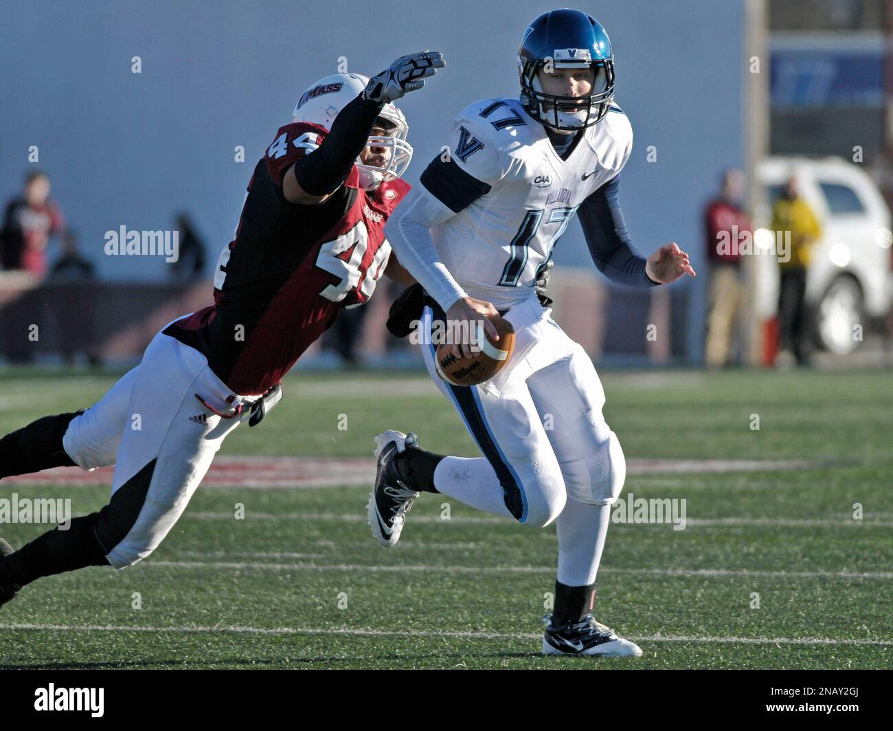 Massachusetts' Perry McIntyre, left, chases down Villanova quarterback ...