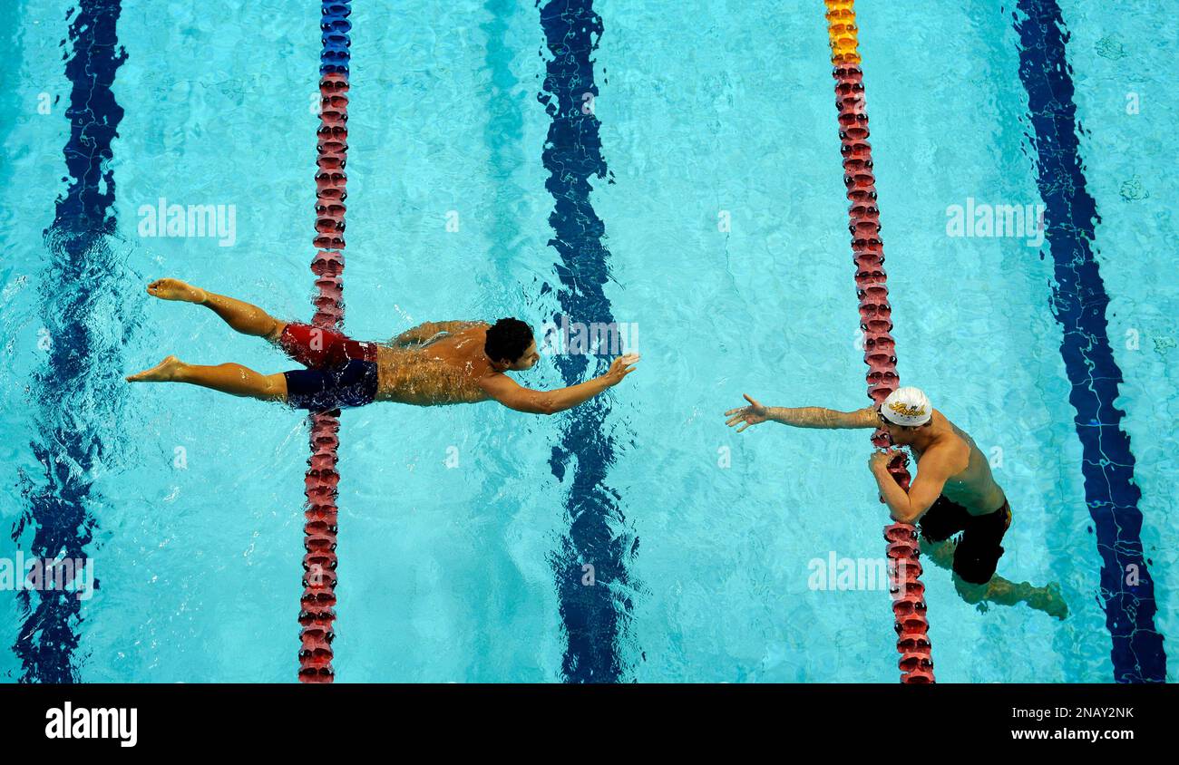 Austria's Markus Rogan, right, reaches over to congratulate Columbian ...