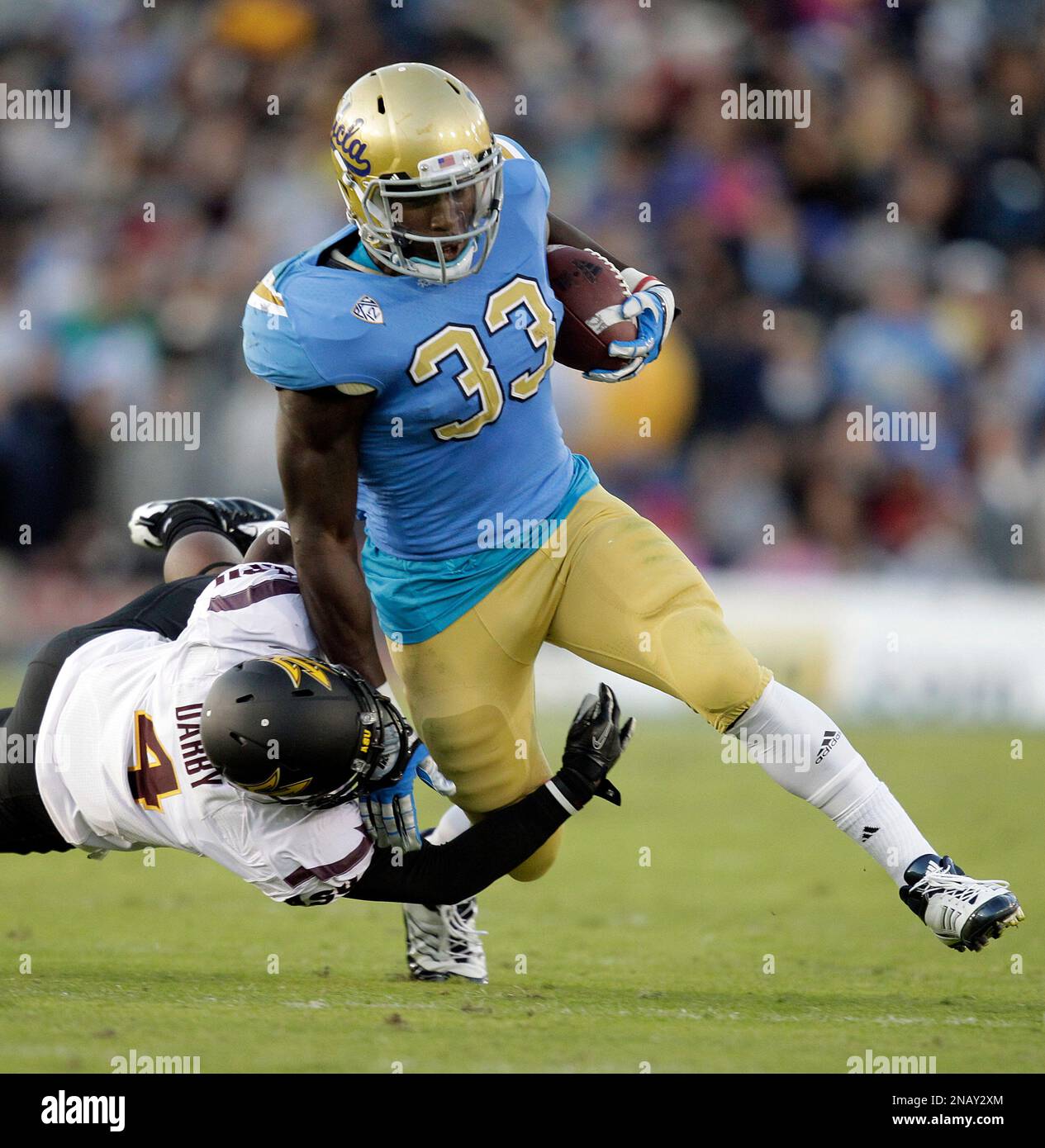 Arizona State safety Alden Darby, left, tackles UCLA running back ...