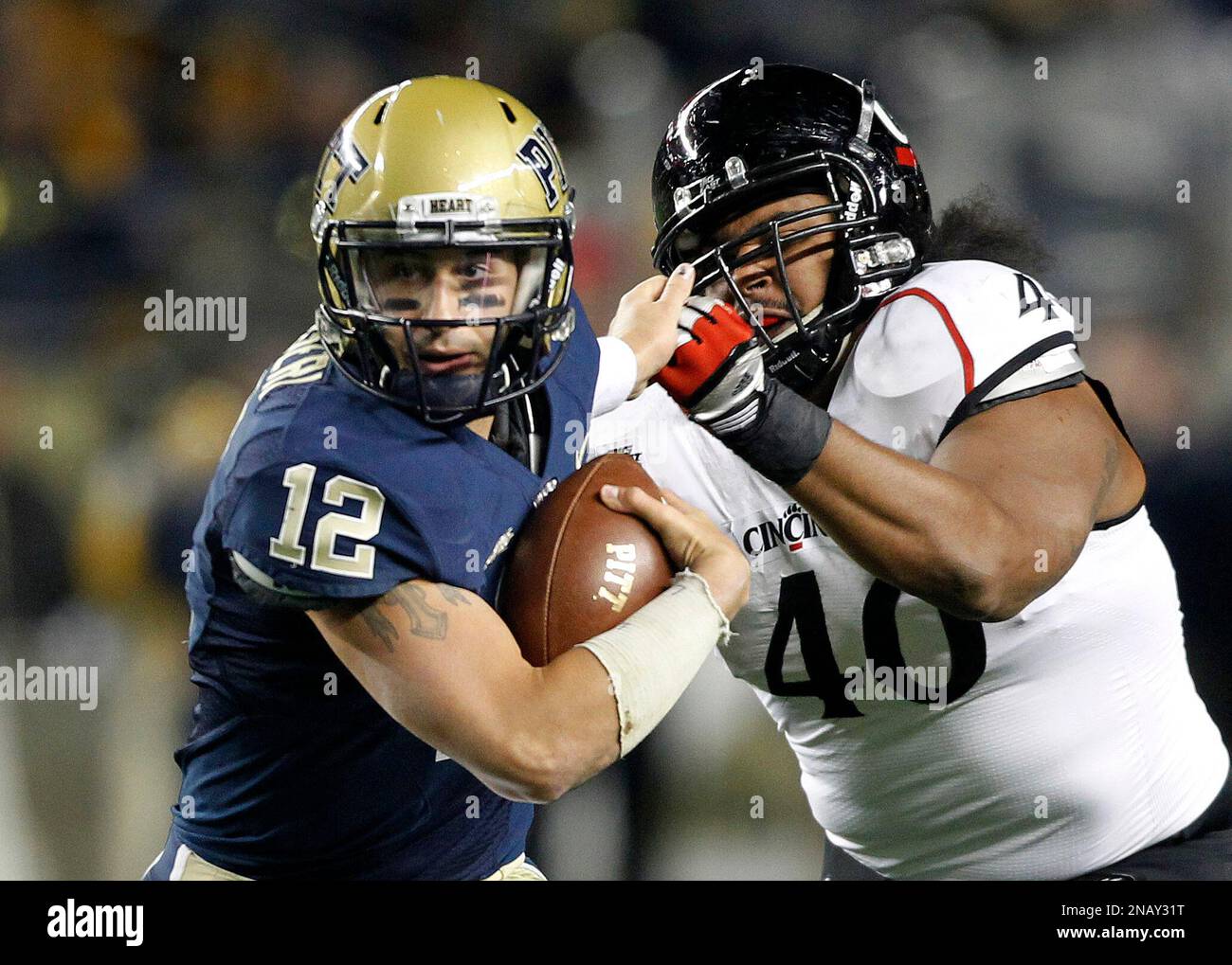 Pittsburgh quarterback Tino Sunseri (12) evades Cincinnati defensive ...