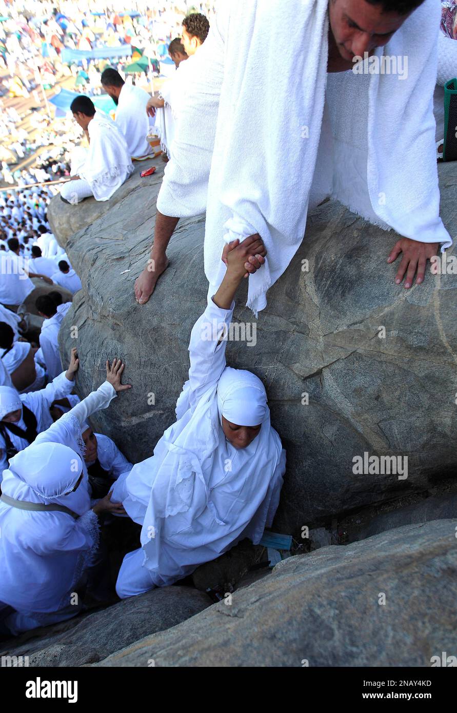 Muslim pilgrims climb a rocky hill called the Mountain of Mercy, on the ...