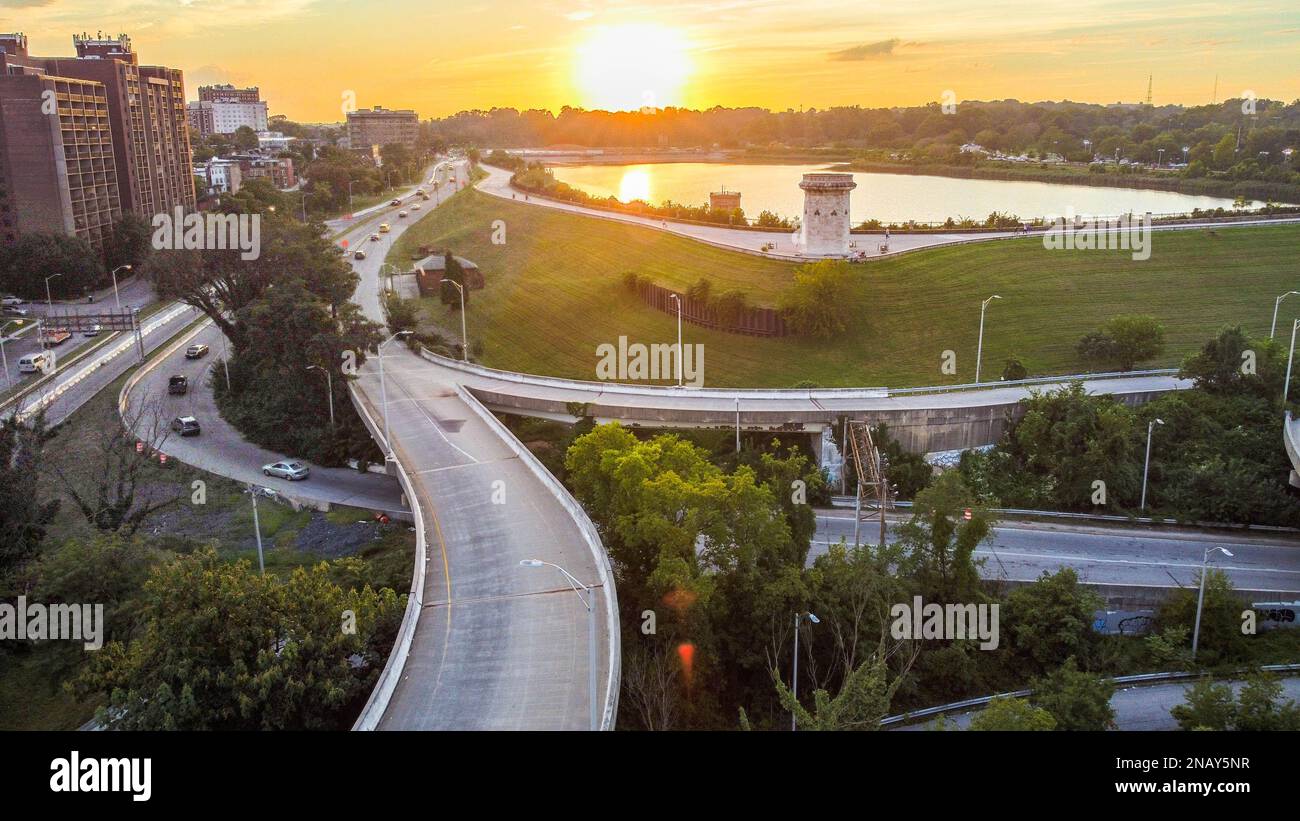 An aerial view of overlapping highways and roads at sunset in downtown ...