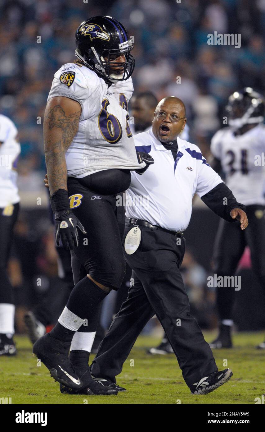 Baltimore Ravens nose tackle Terrence Cody (62), left, is helped off ...