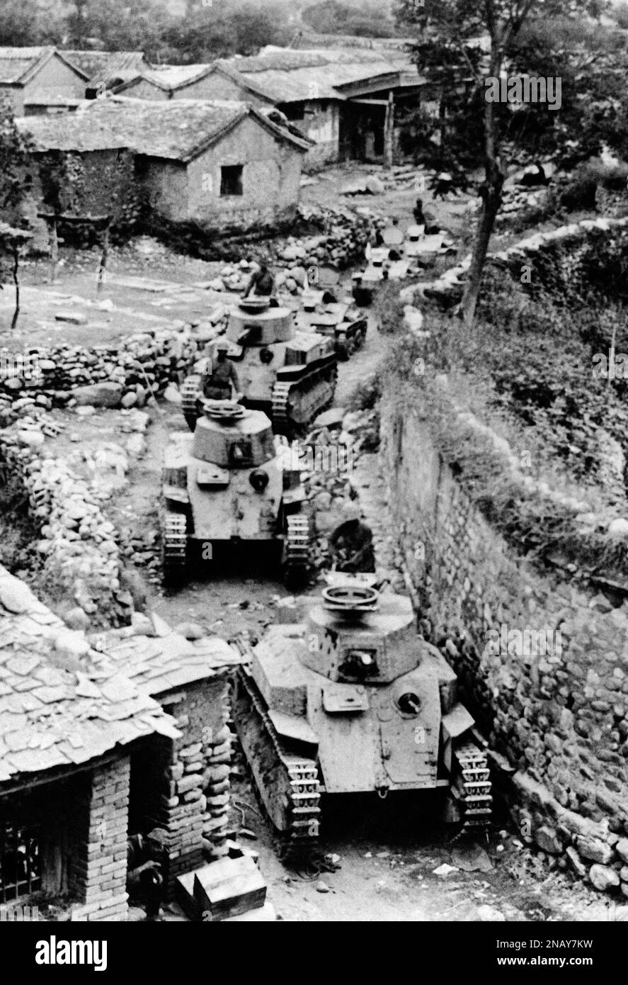 Modern Japanese tanks rumbling along an ancient, rugged road in North China, on Sept. 28, 1937 ...