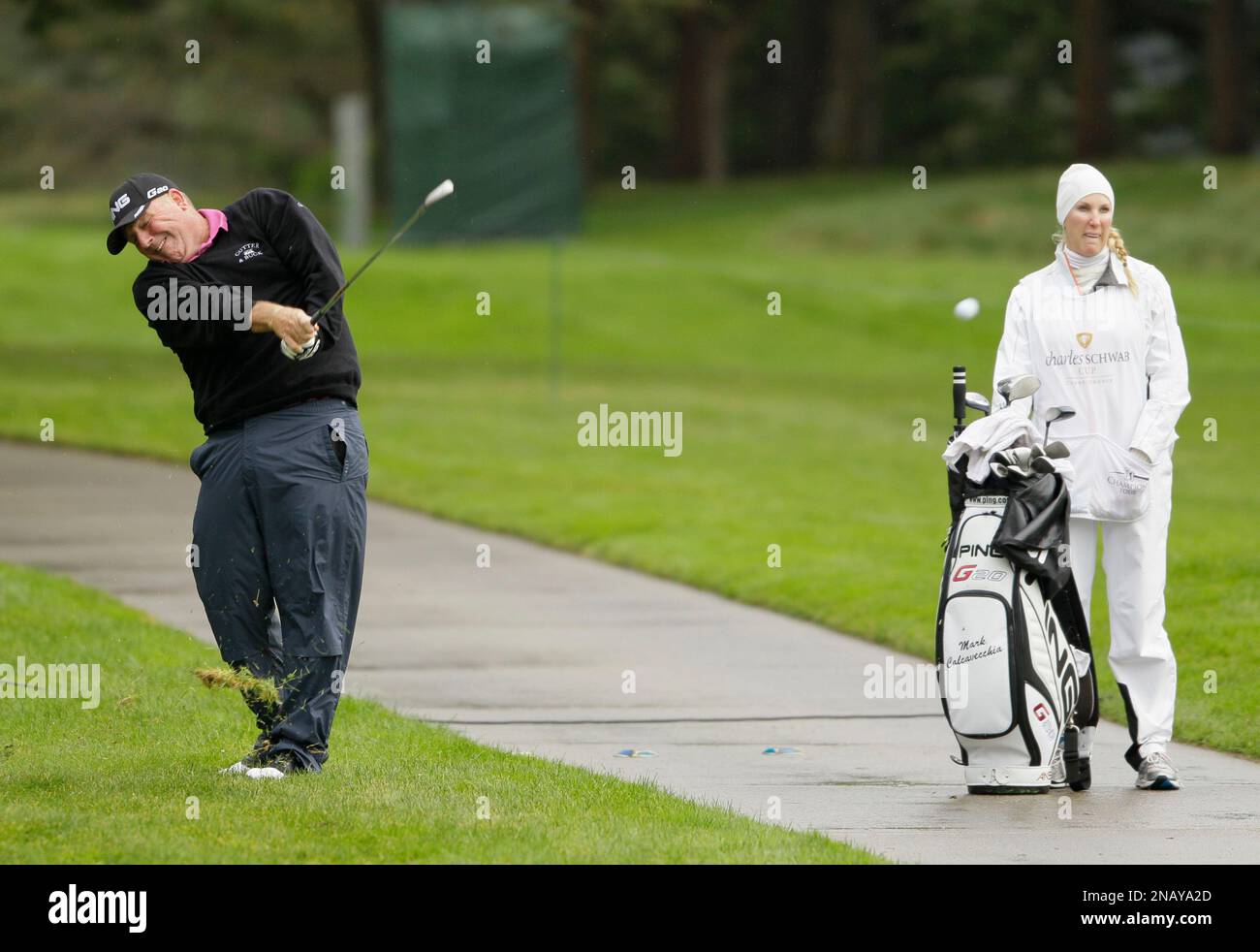 Mark Calcavecchia hits an approach shot near a cart path on the 16th ...