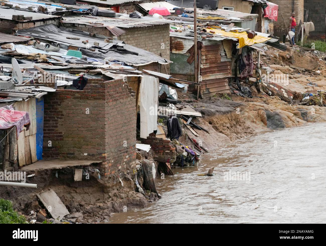 A man looks on from a squatter camp on the edge of the Jukskei river by ...