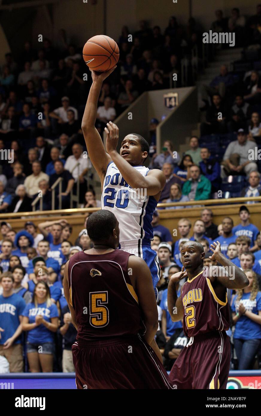 Duke's Andre Dawkins (20) shoots as Shaw's Mohammed Abdur-Rahim (5) and Malik Alvin (2) defend ...