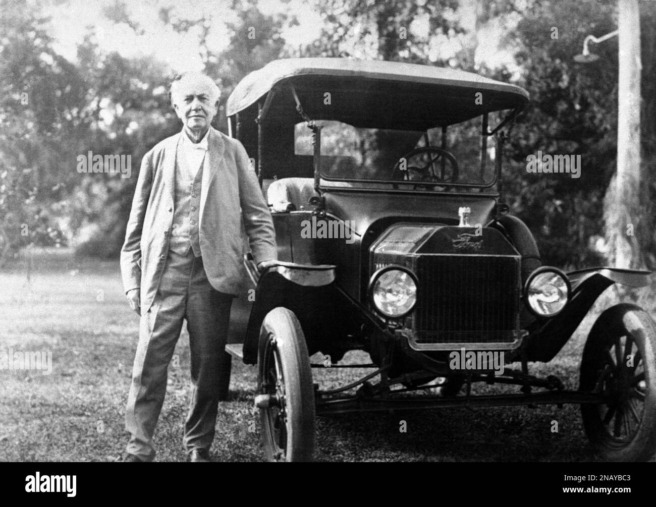 Thomas A. Edison poses with a Ford automobile at an unknown location ...