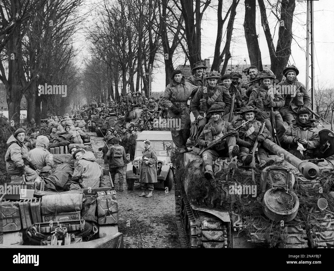 British infantry crowd on tanks and other vehicles as they mass for ...